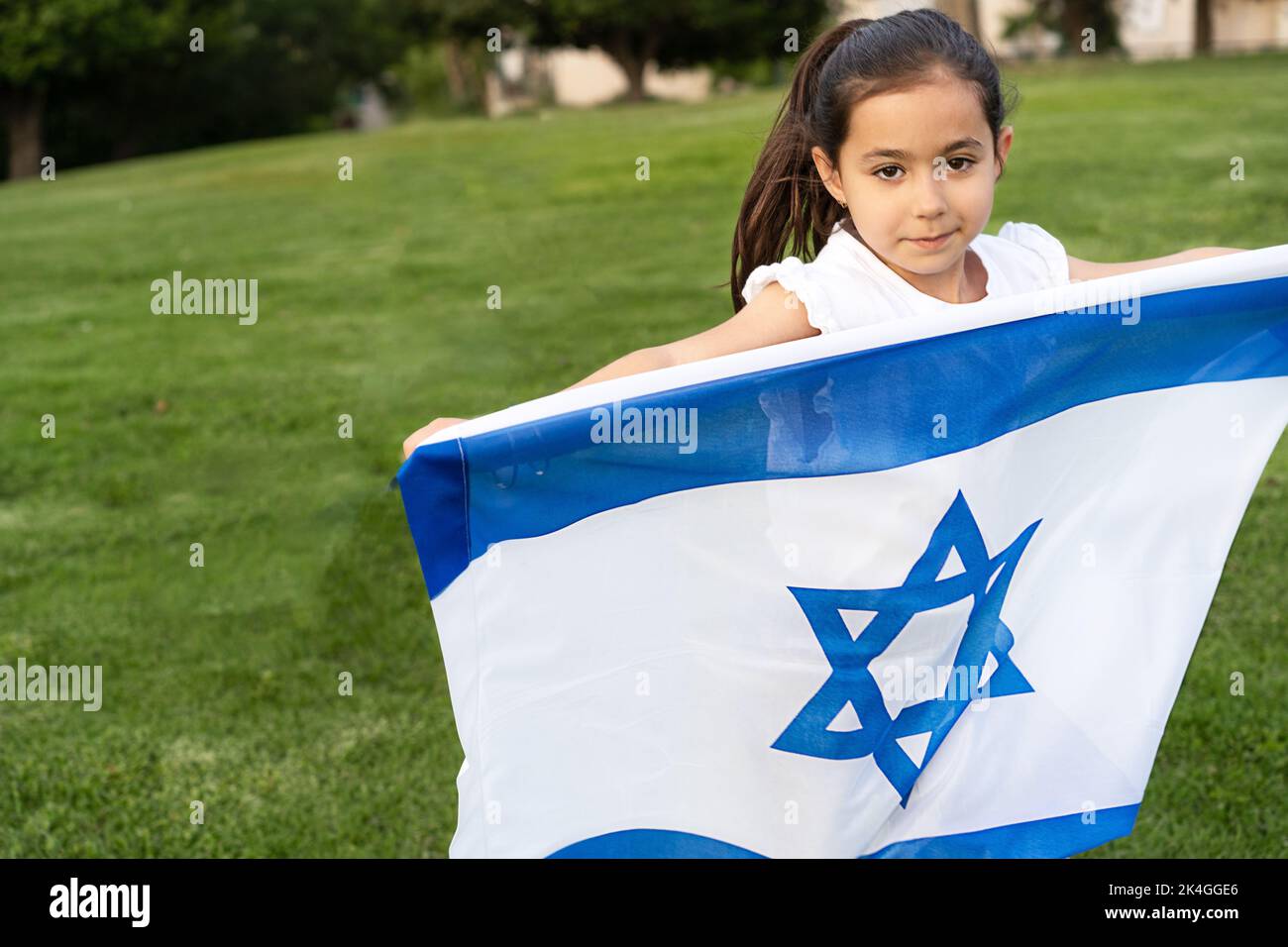 Happy child holding Israel flag and running. Young girl with Israeli ...