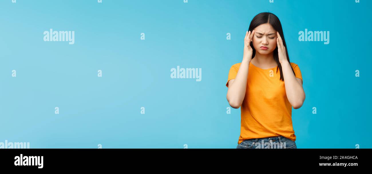 Distressed tired asian woman dark haircut cringe touch temples, suffer ...