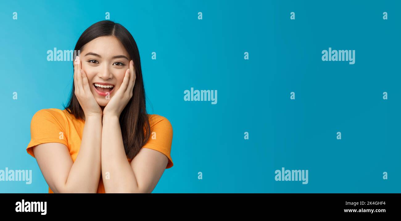 Flirty cute asian girl look surprised, express admiration and joy ...