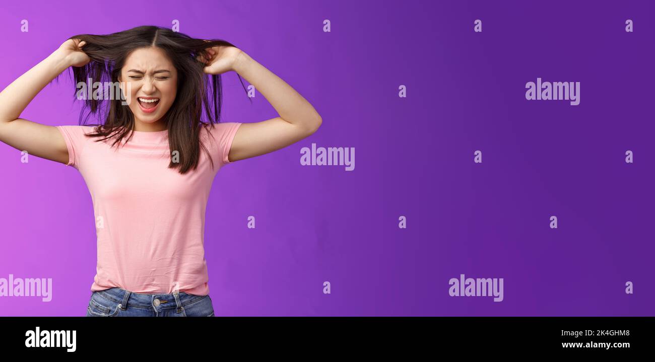 Upset distressed asian brunette girl frowning screaming, pull out hair ...