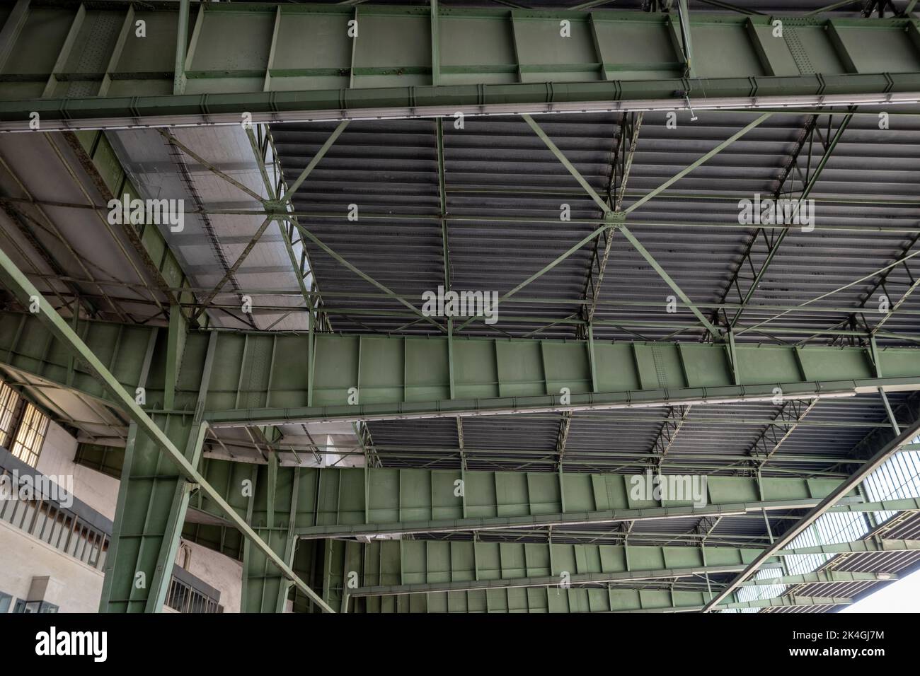 View under high ceiling of open interior space with huge steel truss ...