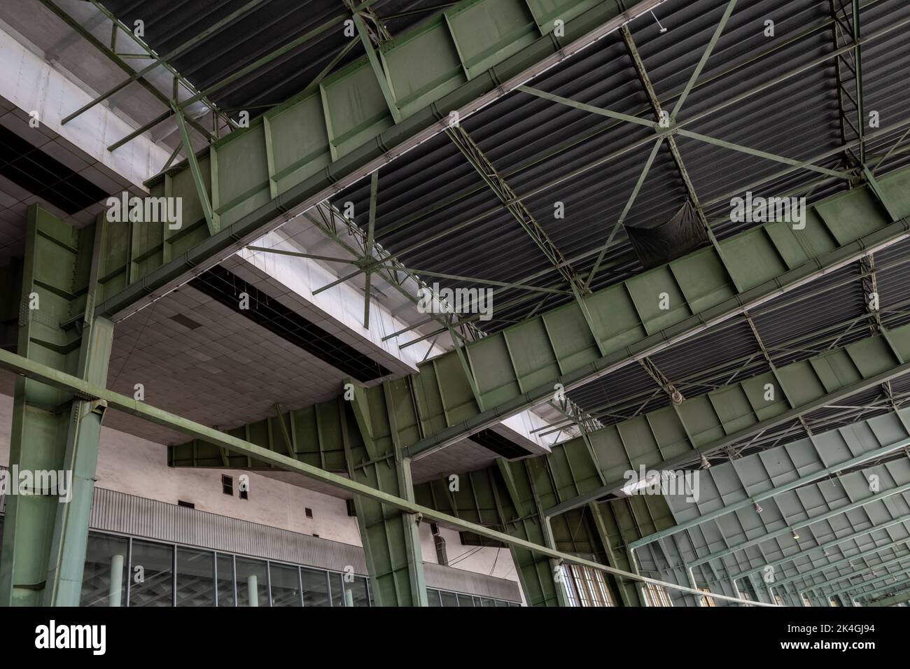 View under high ceiling of open interior space with huge steel truss ...