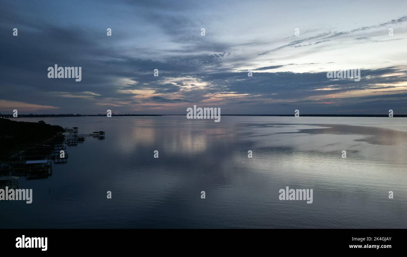 A scenic shot of the seashore with trees at late sunset Stock Photo - Alamy