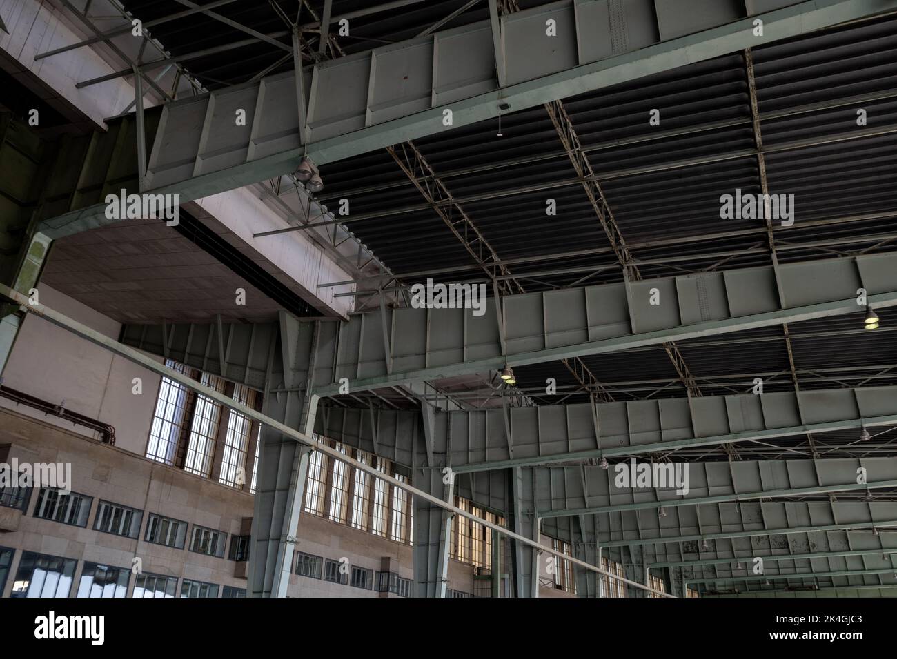 View under high ceiling of open interior space with huge steel truss ...