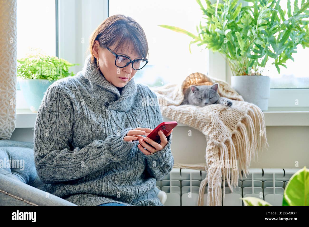 Woman home radiator cosy hi-res stock photography and images - Alamy