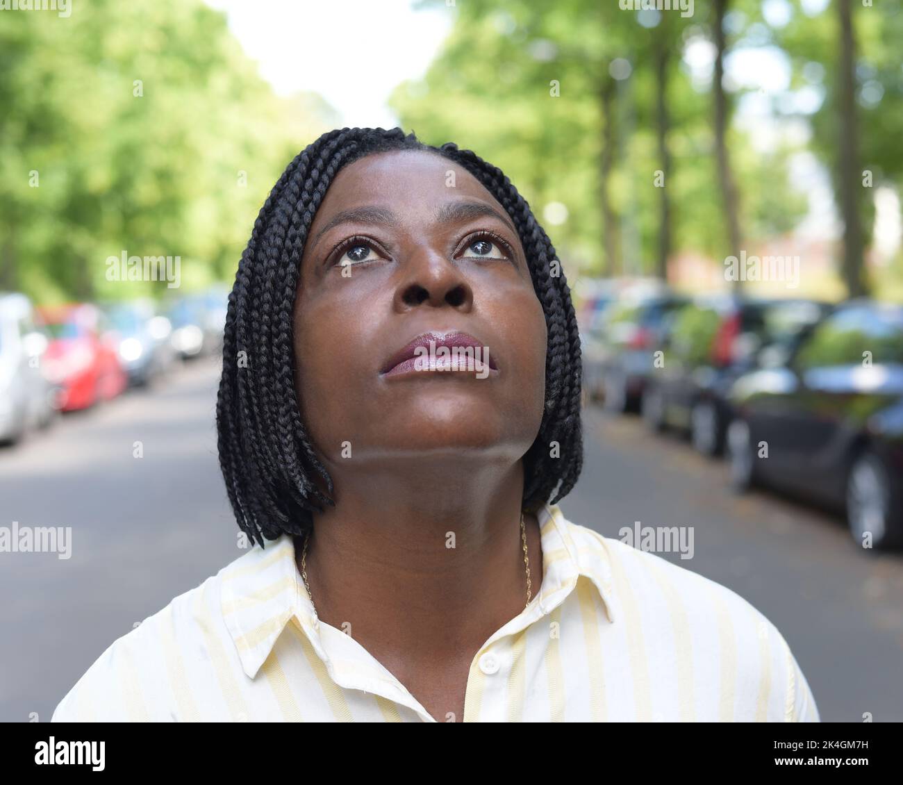Girl Sitting Down Looking Up At The Sky