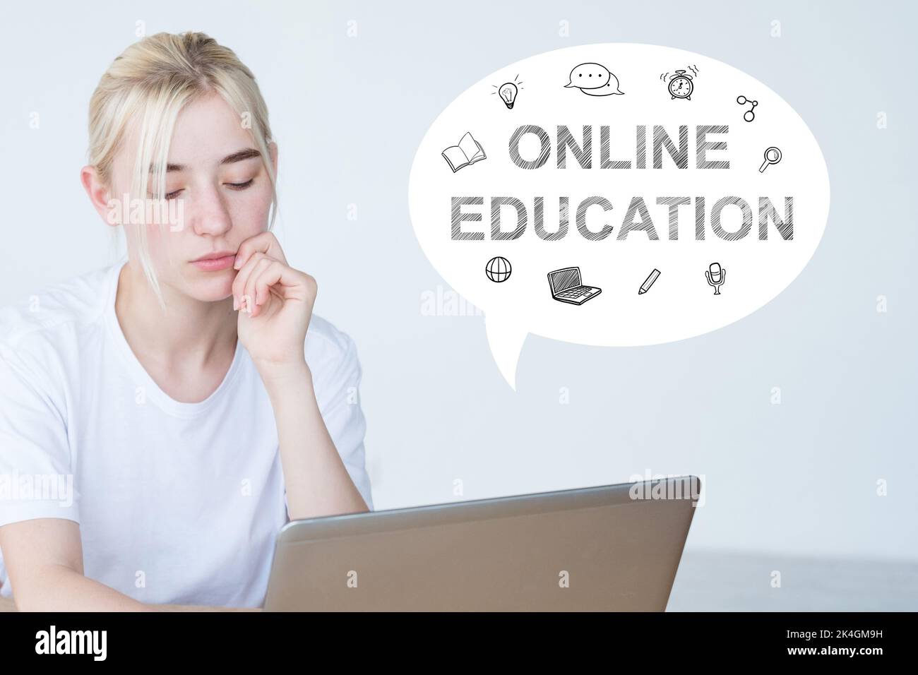 Online education. Remote study. Language course. Pensive girl watching video lesson on laptop in ...