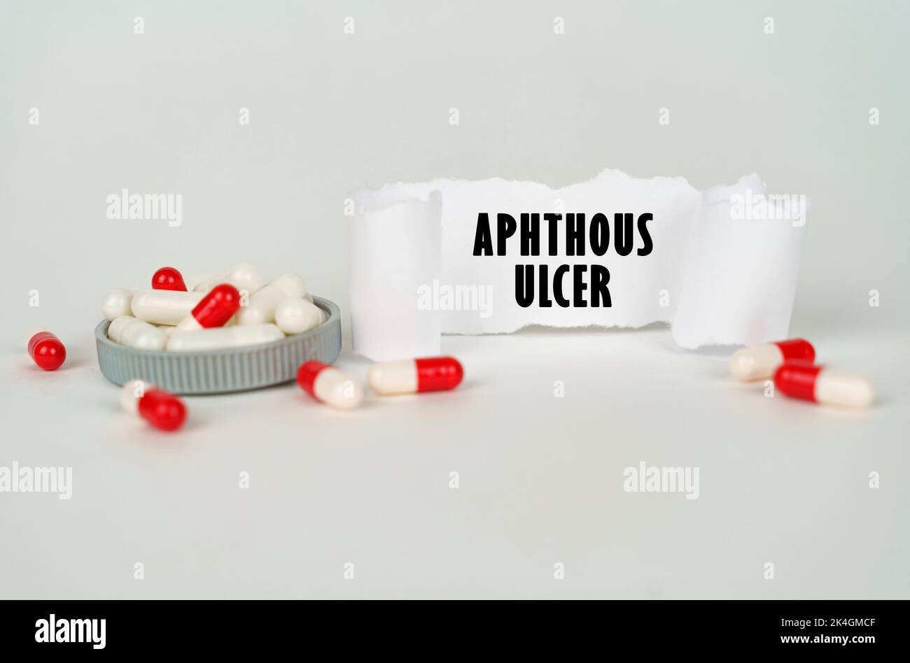 Medical concept. On a gray background, medical capsules and a paper ...