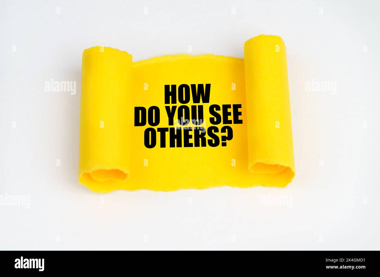 On a white surface, a yellow scroll of paper with the inscription - HOW ...