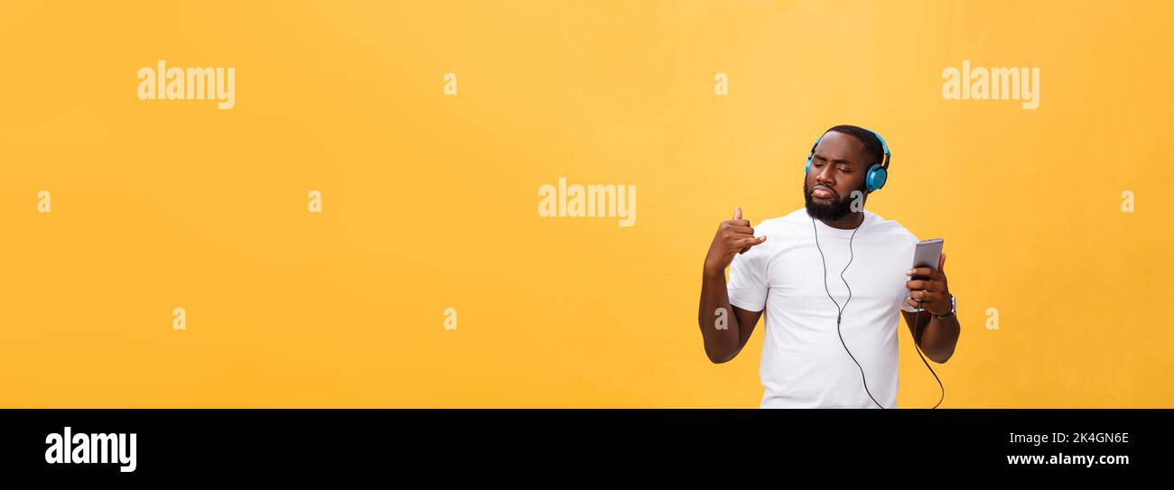 African American man with headphones listen and dance with music ...