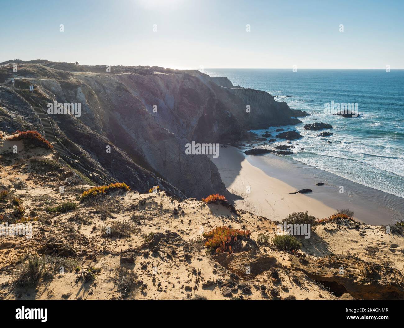 View of empty Praia da Arquinha beach with ocean waves, cliffs and ...