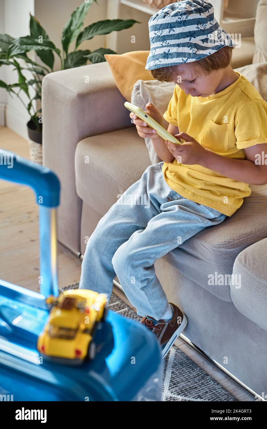 Child using phone on resort hi-res stock photography and images - Alamy