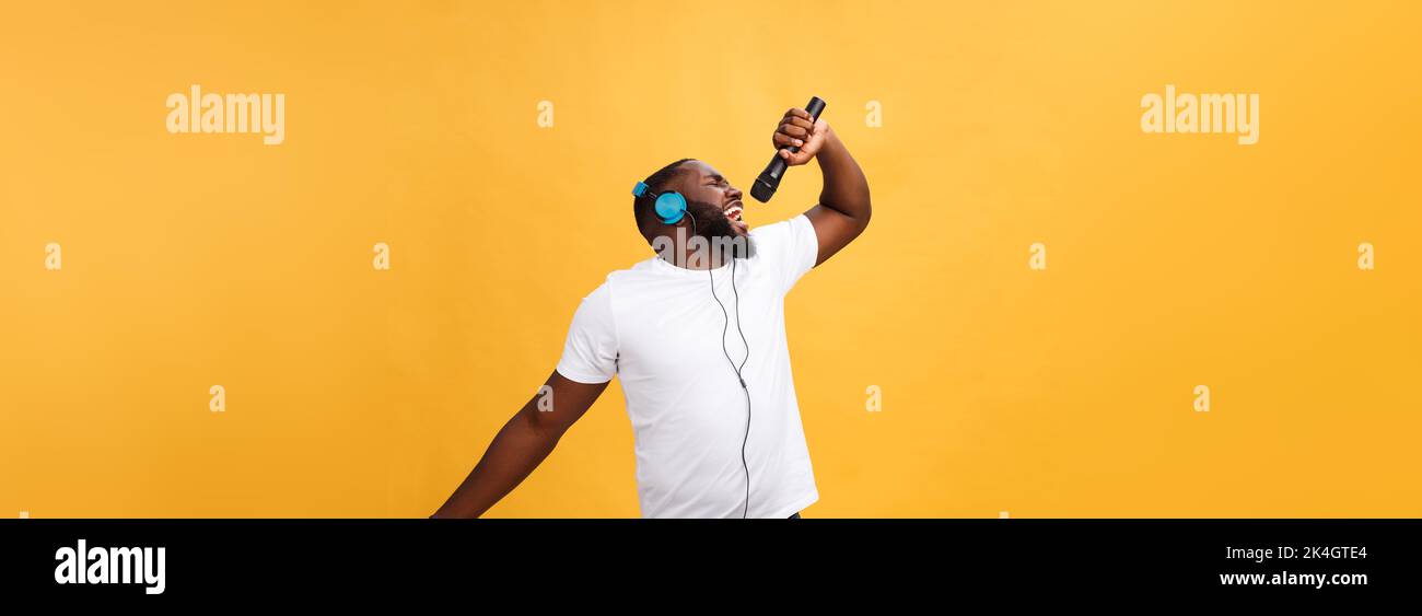 Portrait of cheerful positive chic handsome african man holding ...
