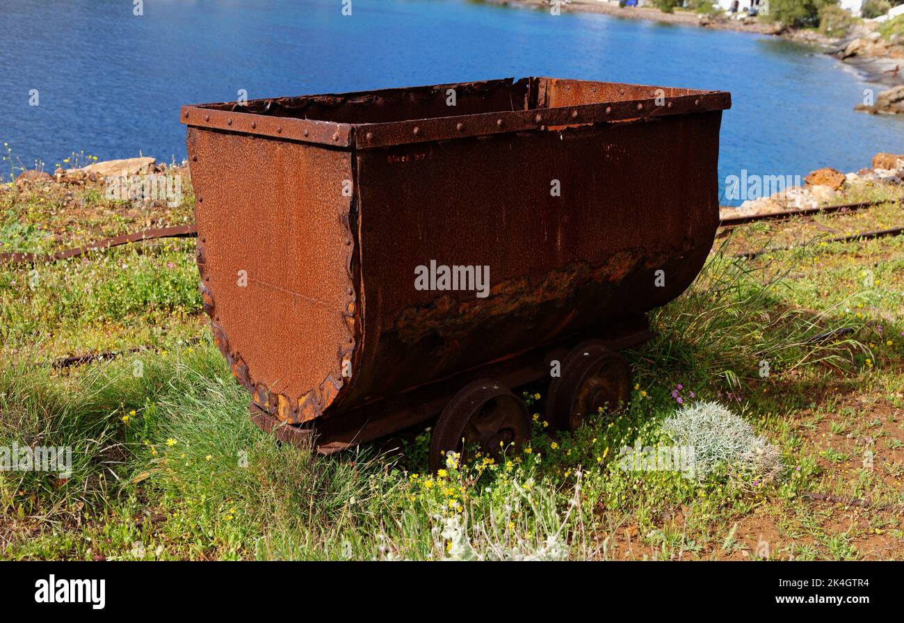 Old rusty coal tub or trolley on tracks, on the sea cliff in Megalo ...