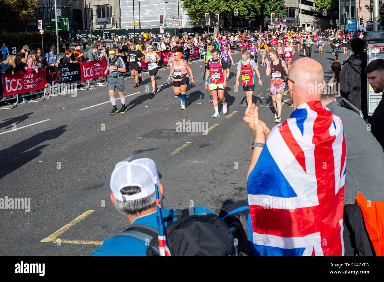 People watching fun runners running in the TCS London Marathon 2022, on ...