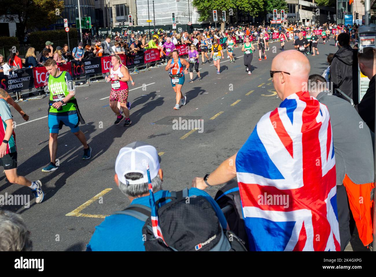 People watching fun runners running in the TCS London Marathon 2022, on ...