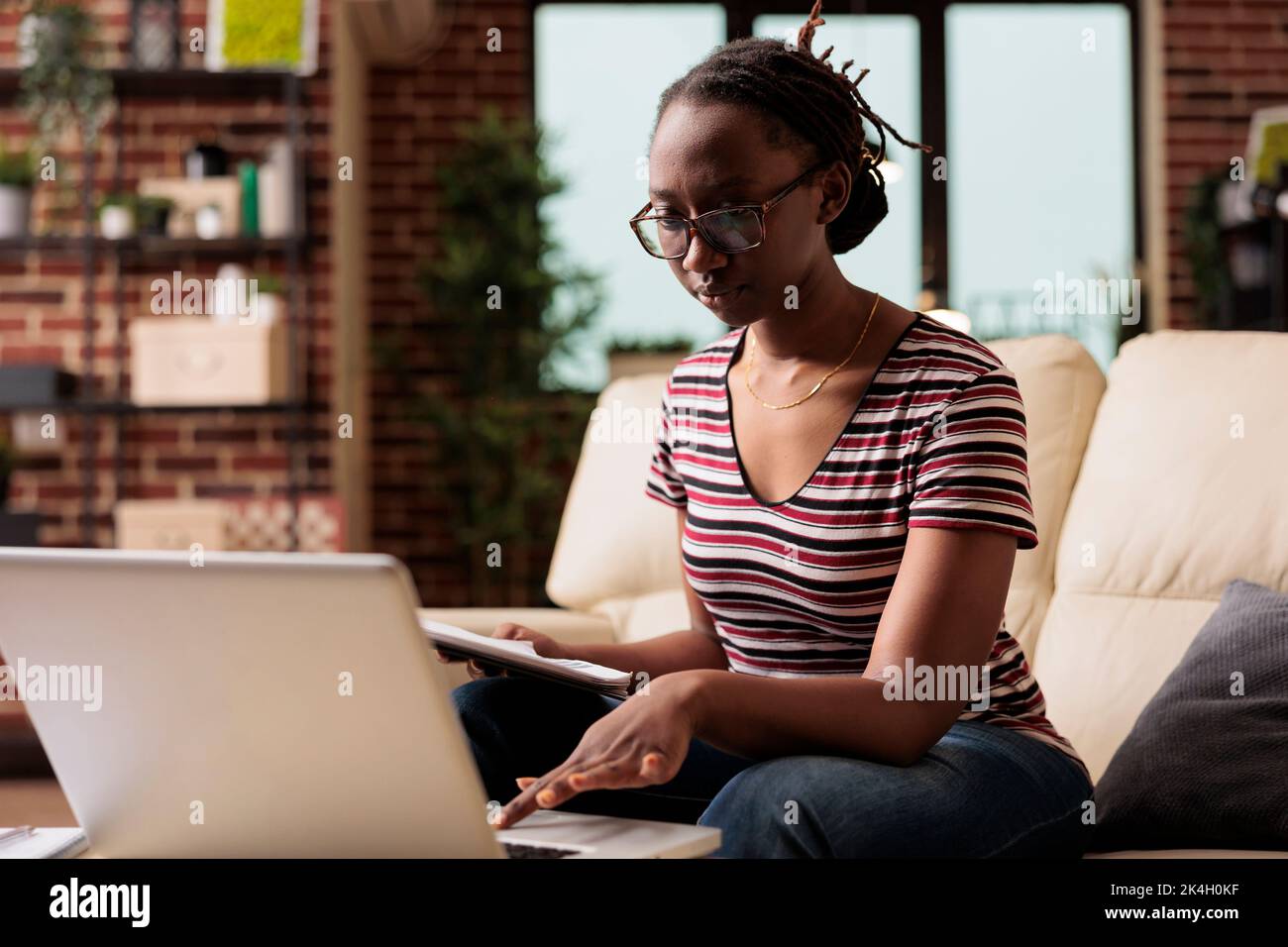 Remote employee holding clipboard with report, working in home office ...