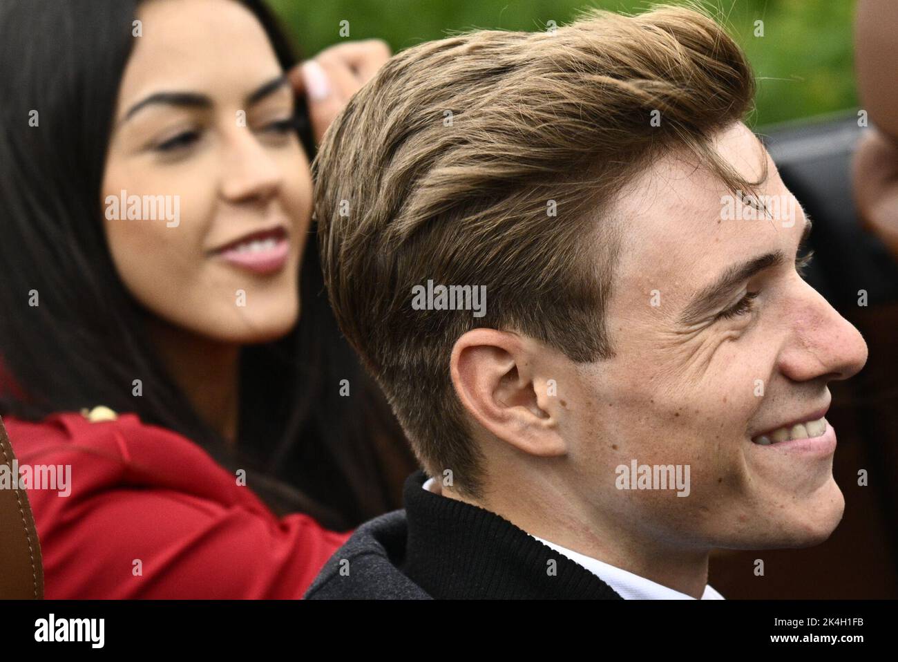 Remco Evenepoel and his partner Oumaima Oumi Rayane sit in a ...