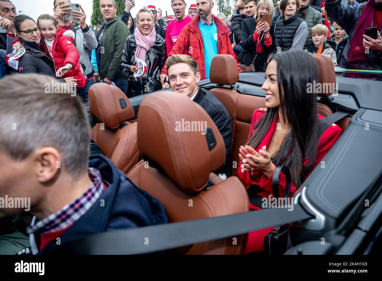 Remco Evenepoel and his partner Oumaima Oumi Rayane sit in a ...