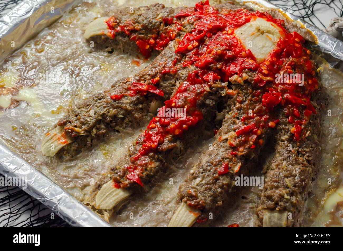 Roasted minced meat formed in the shape of a hand, topped with a tomato ...