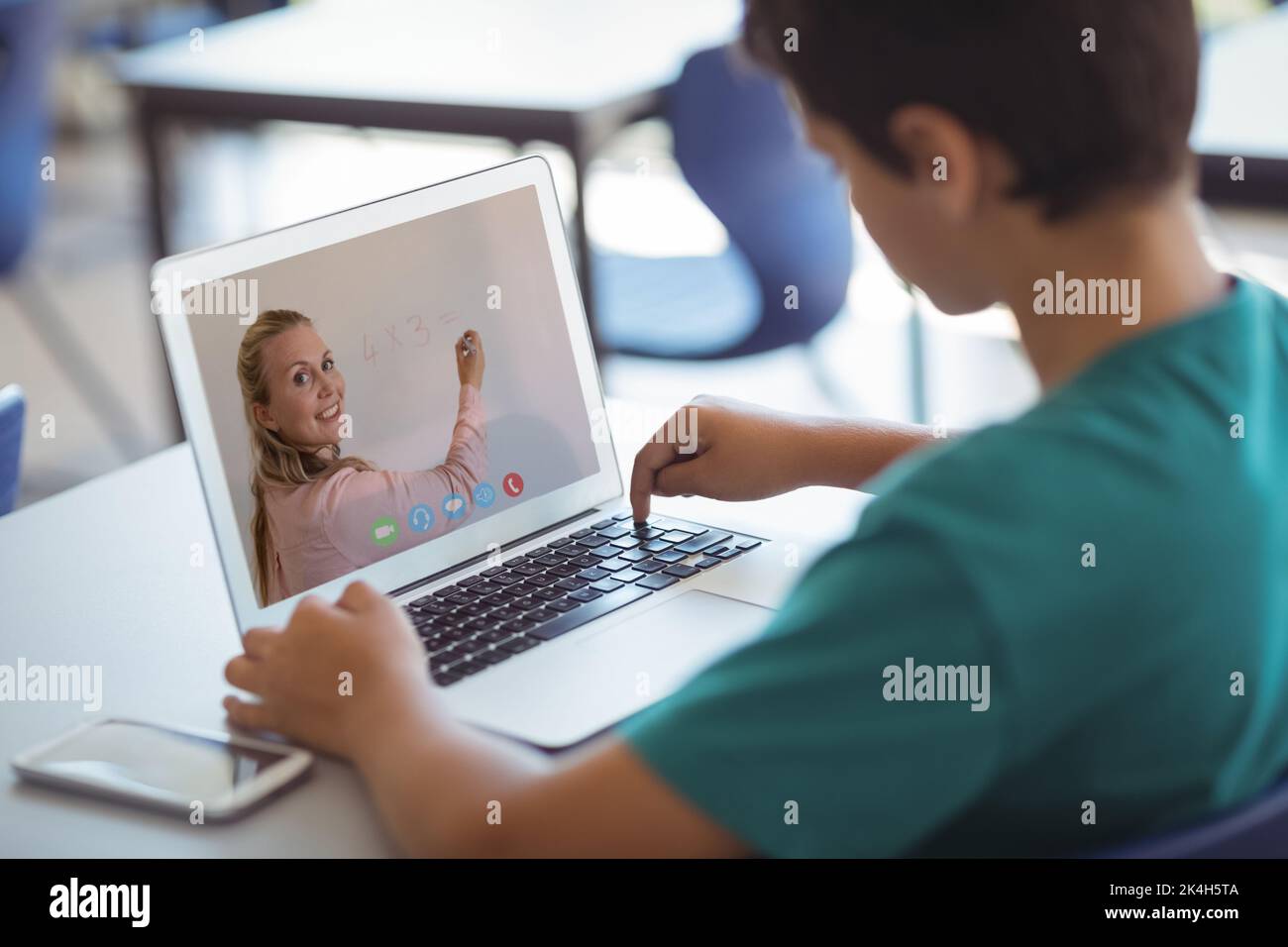 Male caucasian student having a video call with female teacher on ...