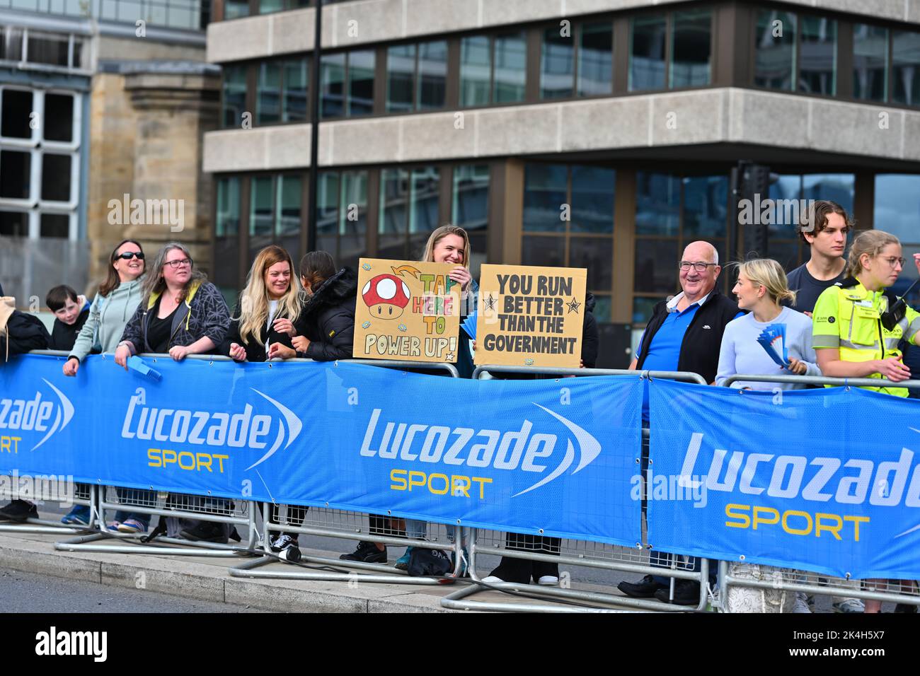 Spectators hold up signage during the 2022 TCS London Marathon. You Run ...