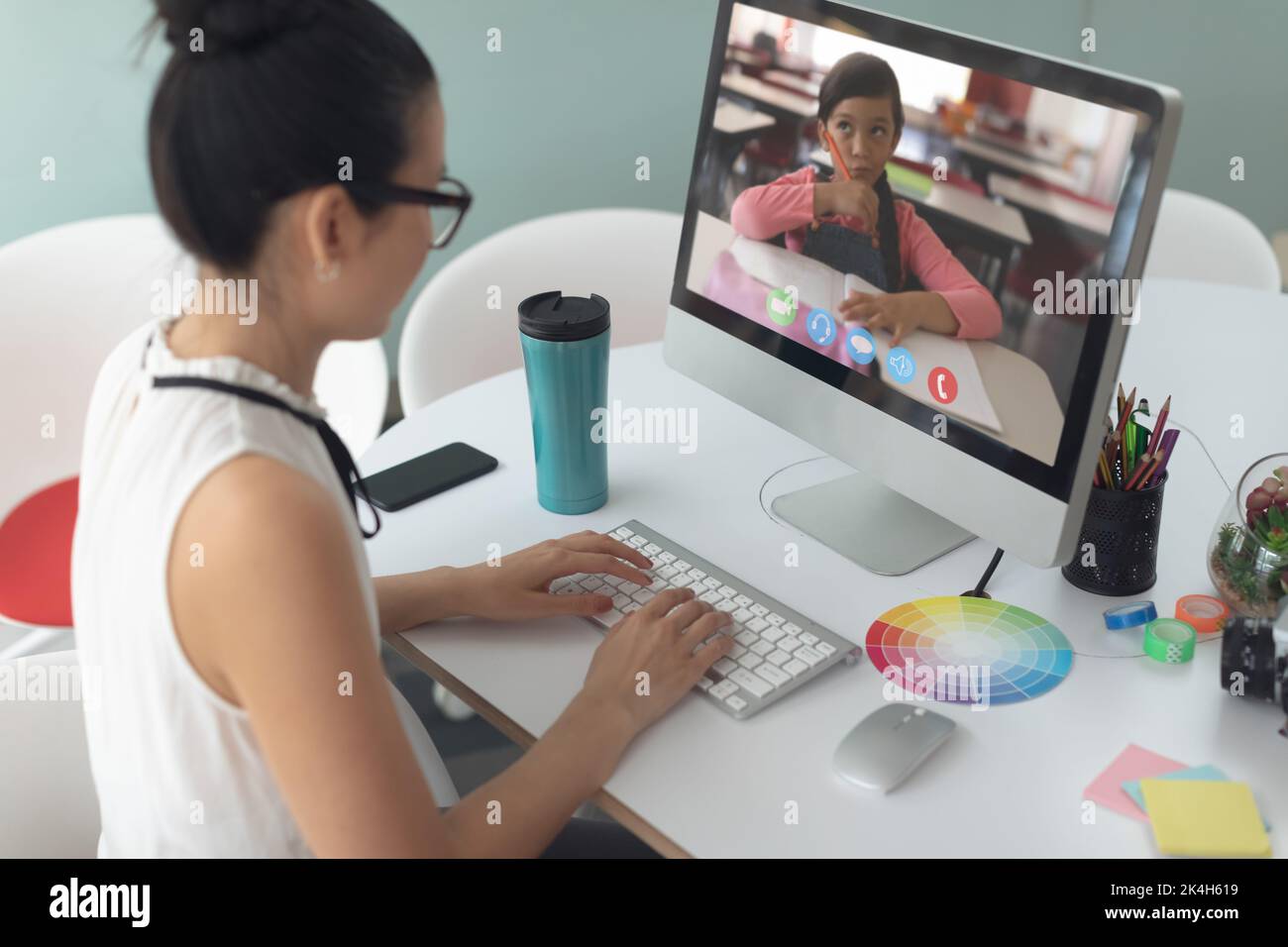 Caucasian female teacher using computer on video call with schoolgirl ...