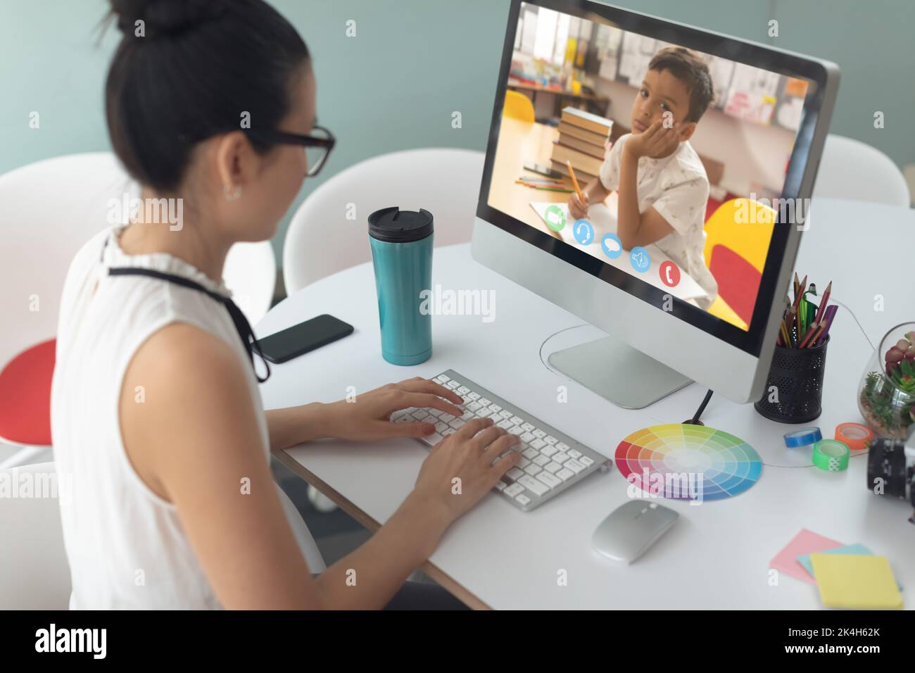 Female teacher having a video call with male student on computer at ...