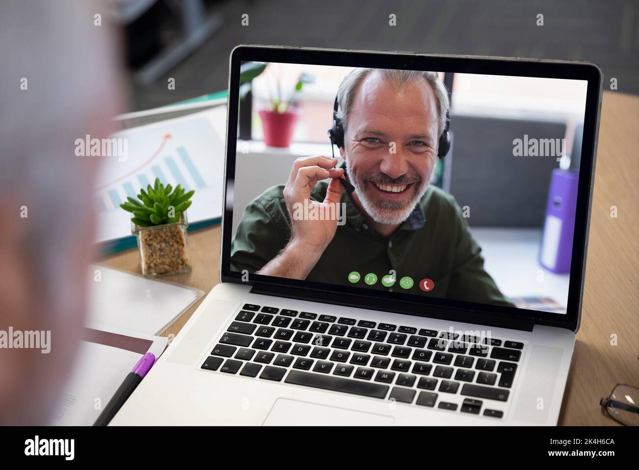 Smiling caucasian businessman displayed on laptop screen during office ...