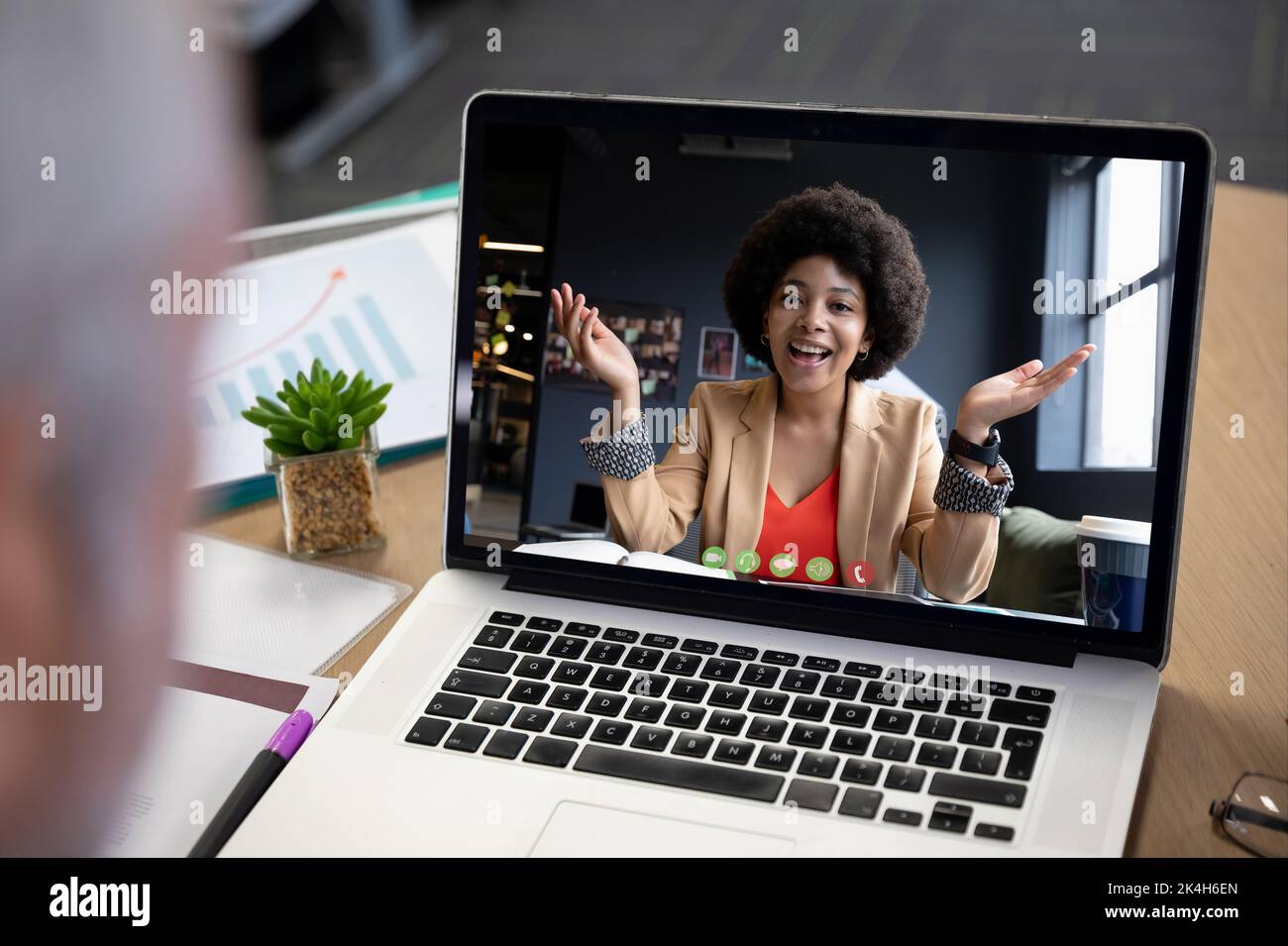 Smiling mixed race businesswoman displayed on laptop screen during ...
