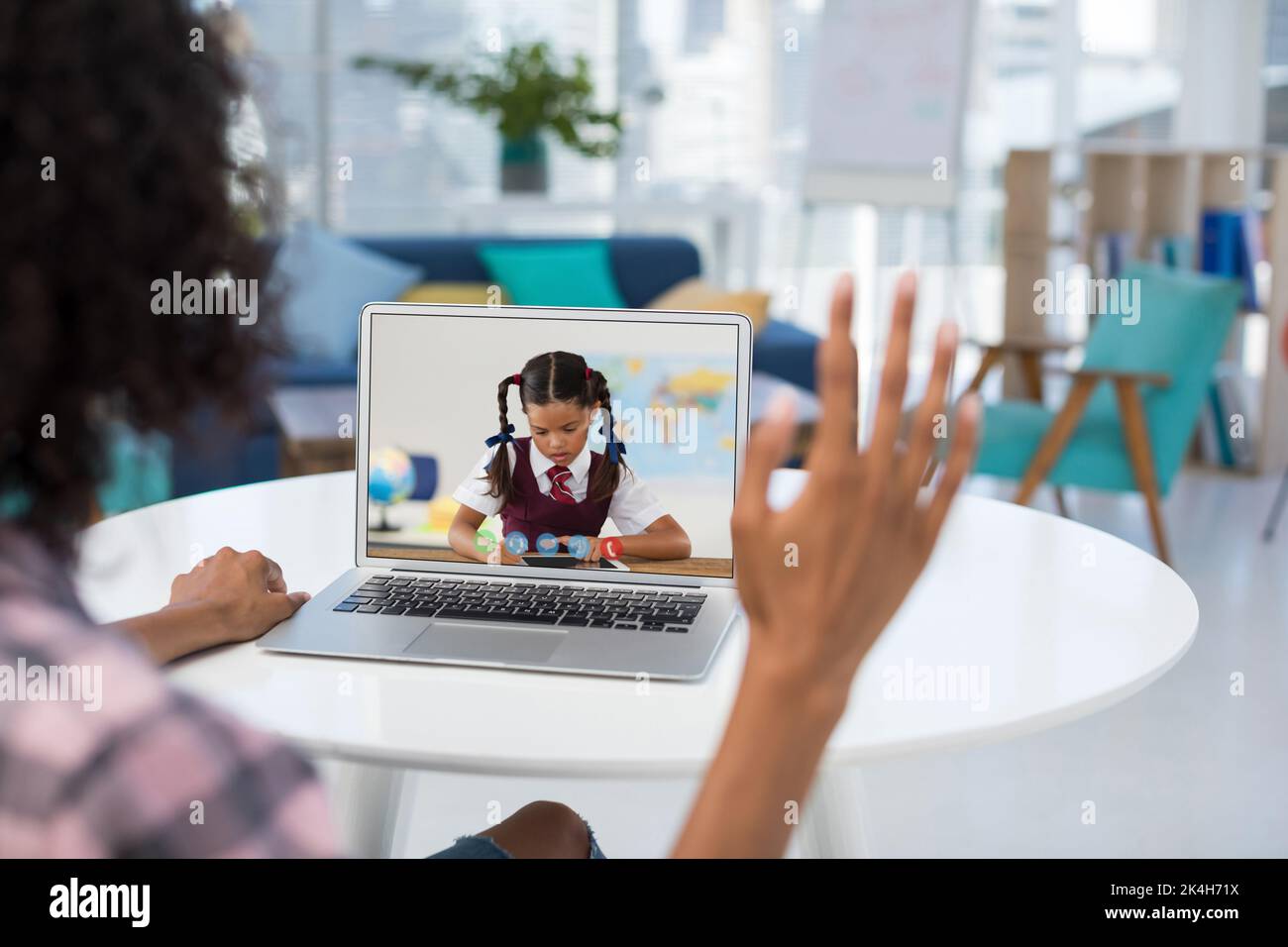 Female teacher having a video call with female student on laptop at ...