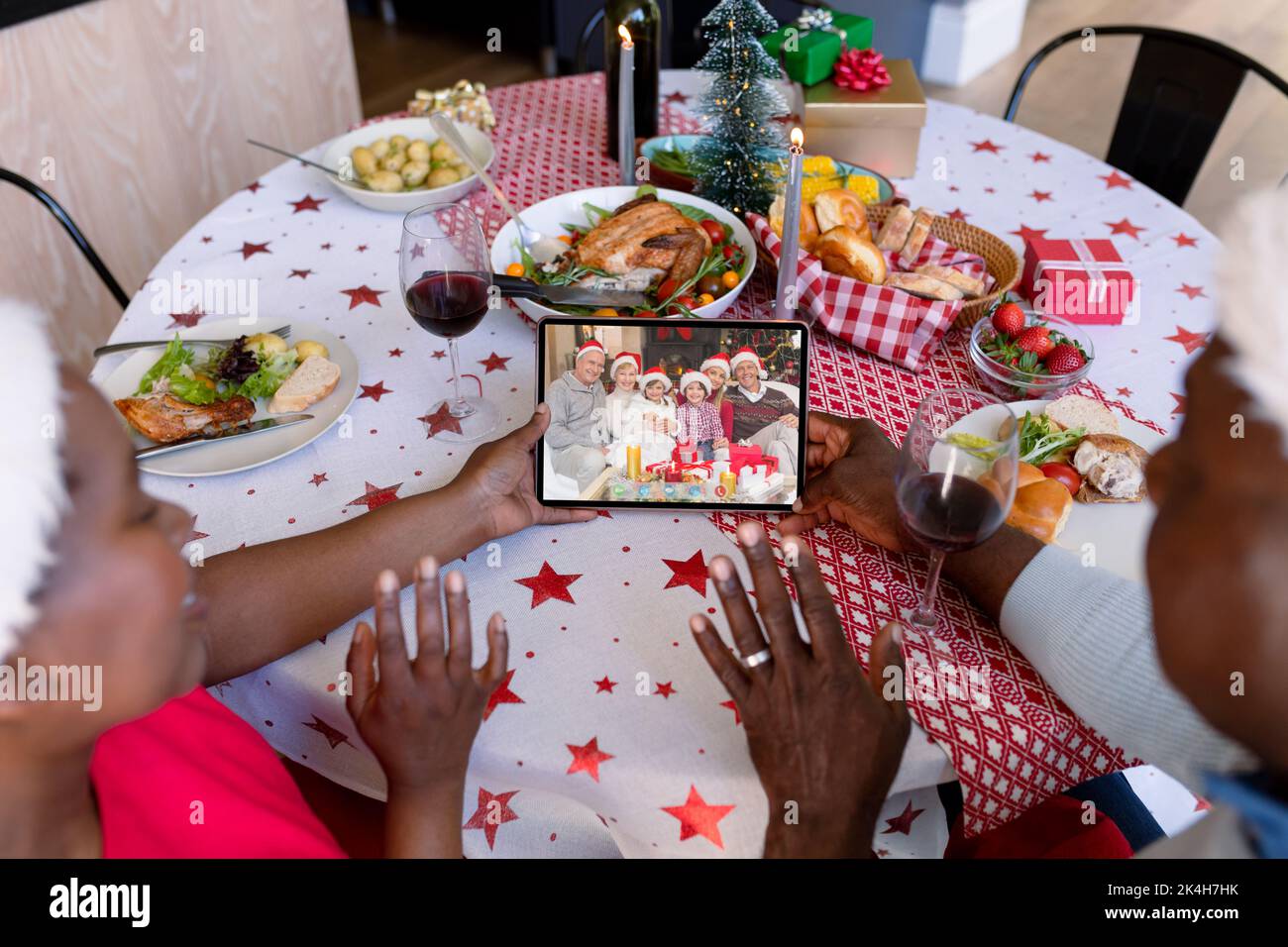 Happy african american couple making tablet christmas video call with ...