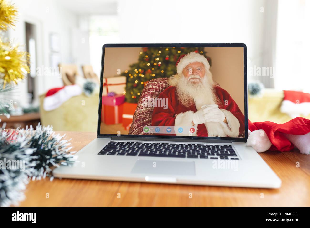 Jolly santa claus smiling on laptop video call interface screen at ...