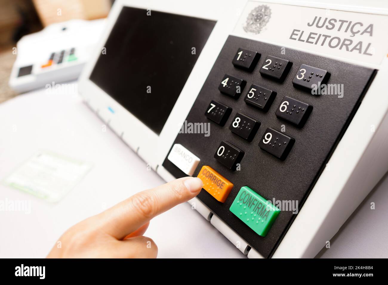 In this photo illustration, a person simulates voting on the electronic ...