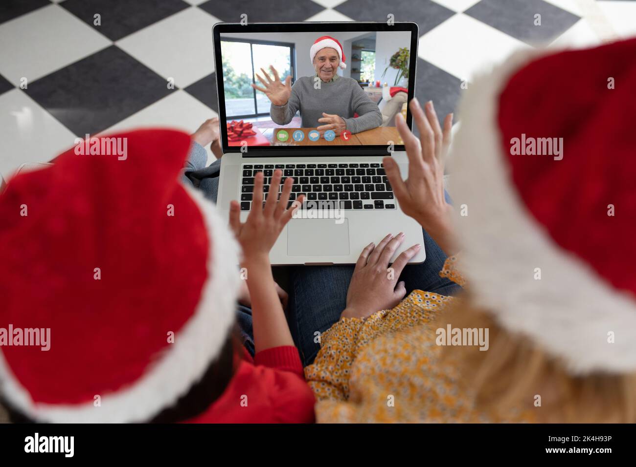 Caucasian mother and child in santa hats on christmas video call on ...