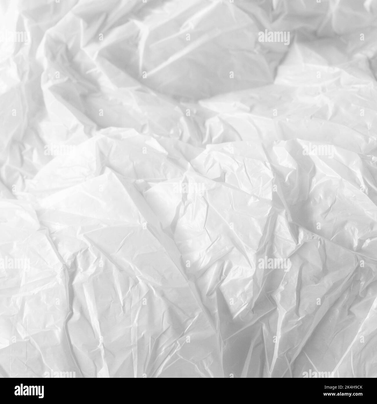 Reflecting light and shadow on creases and folds in scrunched white ...