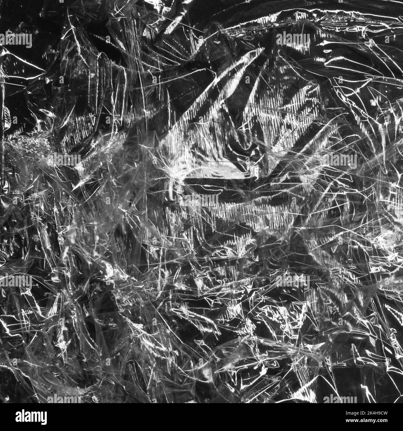 Reflecting light and shadow on creases and folds in scrunched clear ...