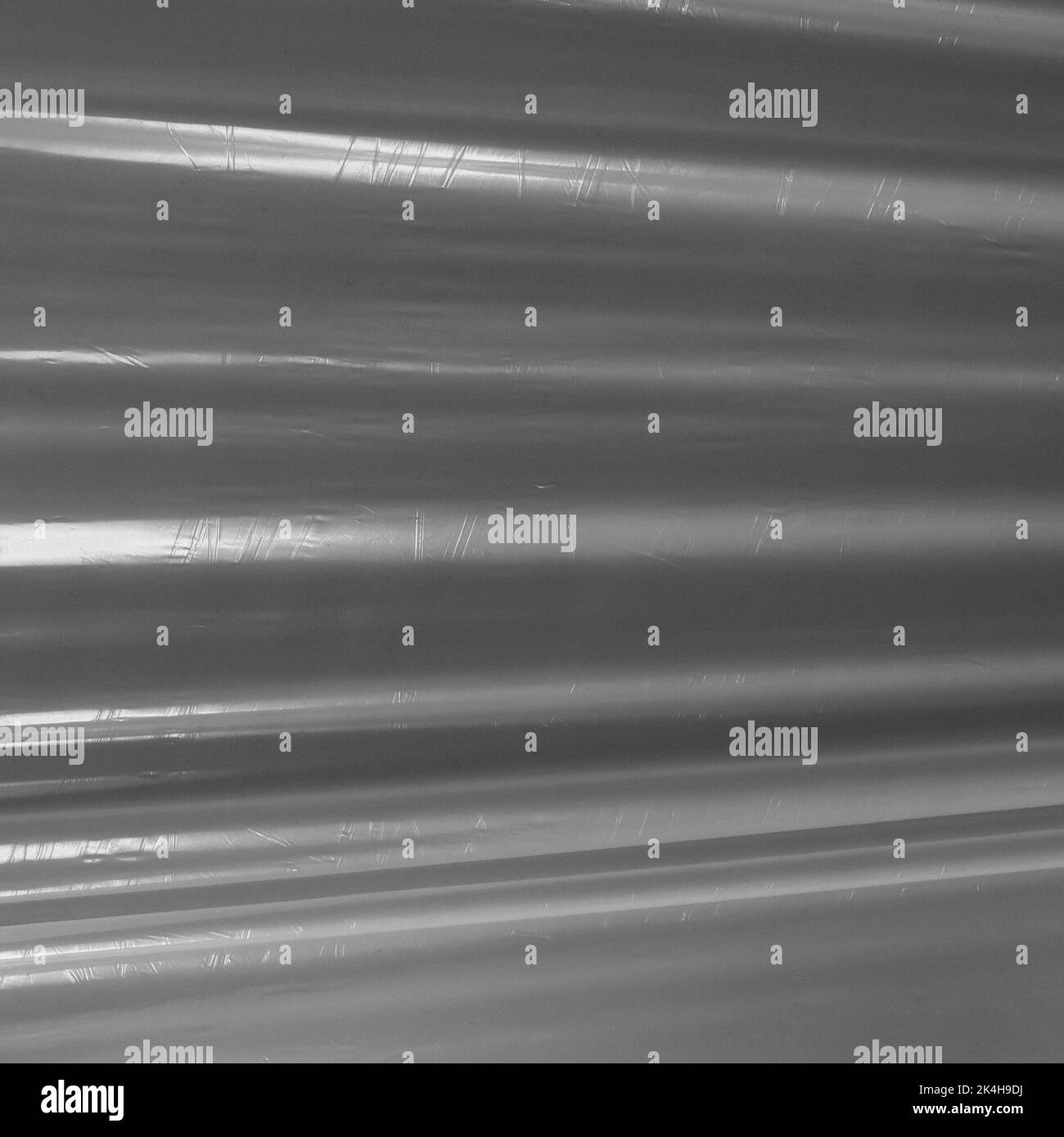 Reflecting light and shadow on creases and folds in stretched plastic ...