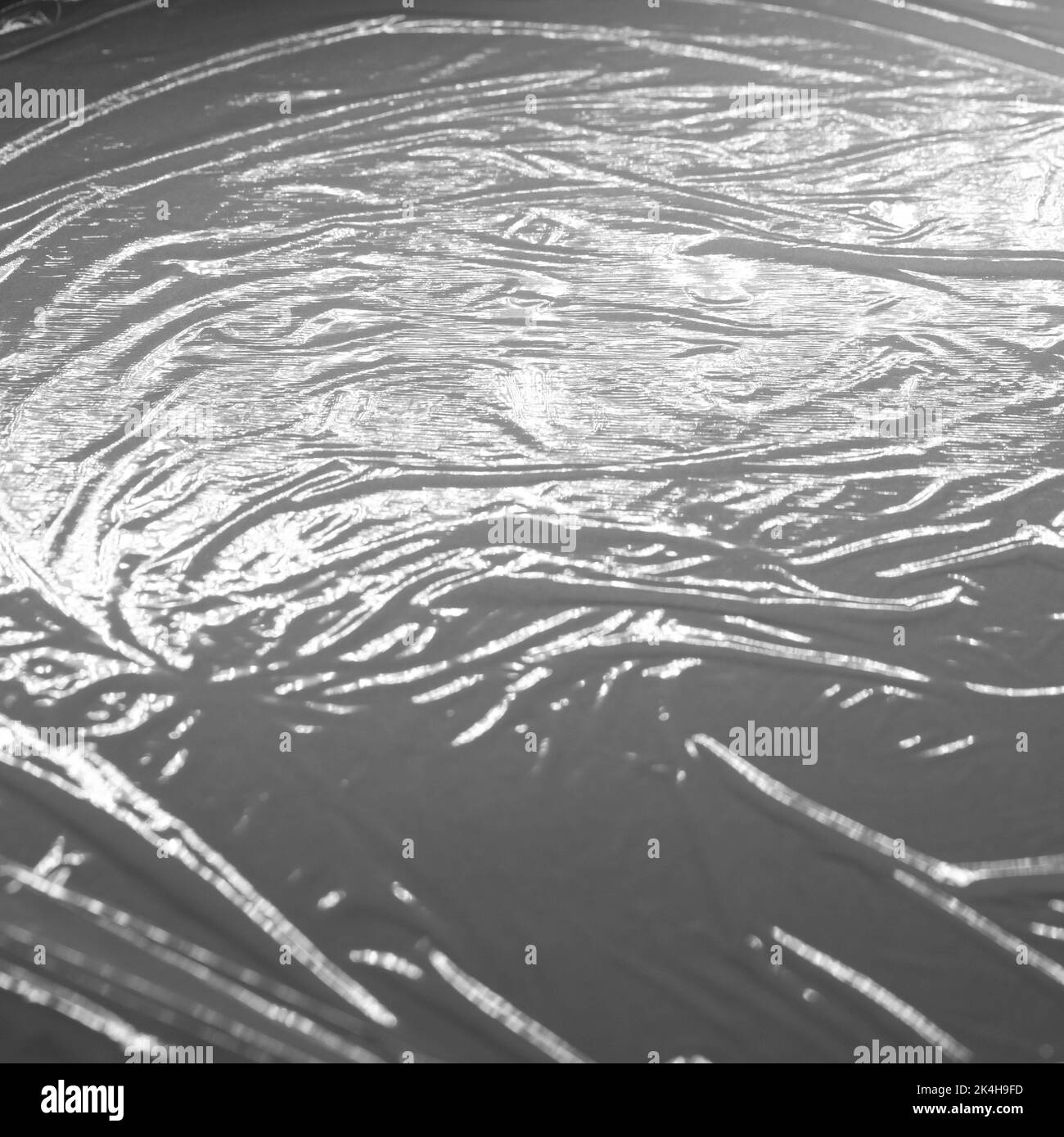 Reflected light and shadow on creases and folds in shiny fabric or ...