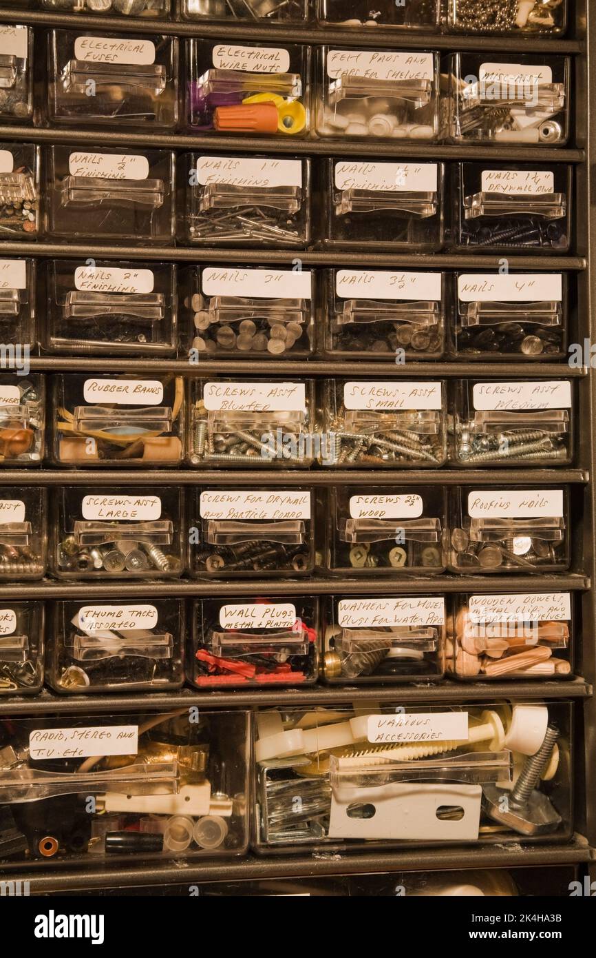 Stored assorted objects including nails, screws, anchor plugs, plastic ...