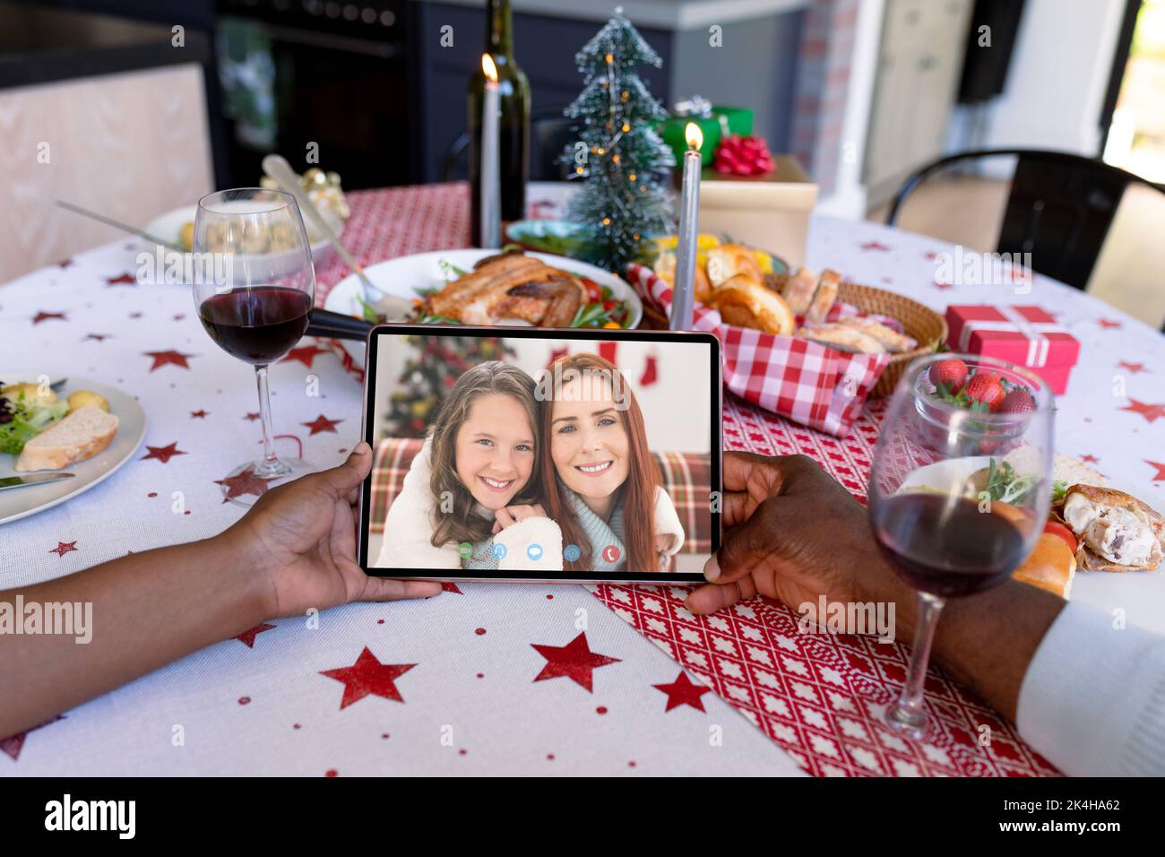 African american couple making tablet christmas video call with smiling ...
