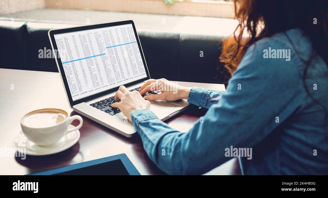 Midsection Of Caucasian Female Programmer Sitting With Coffee Using Laptop With Coding On