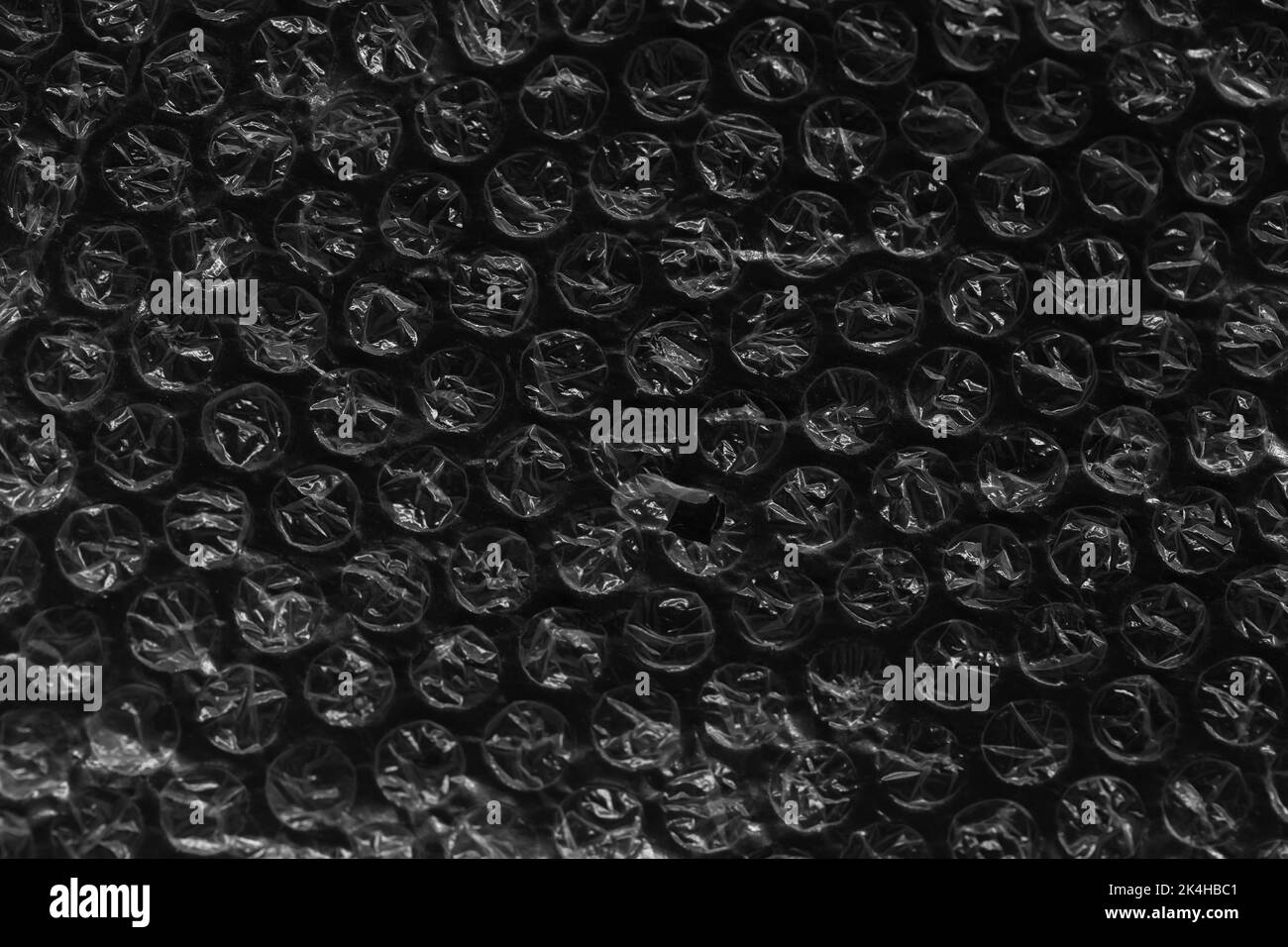 Reflecting light and shadow on creases and folds in plastic bubble wrap ...