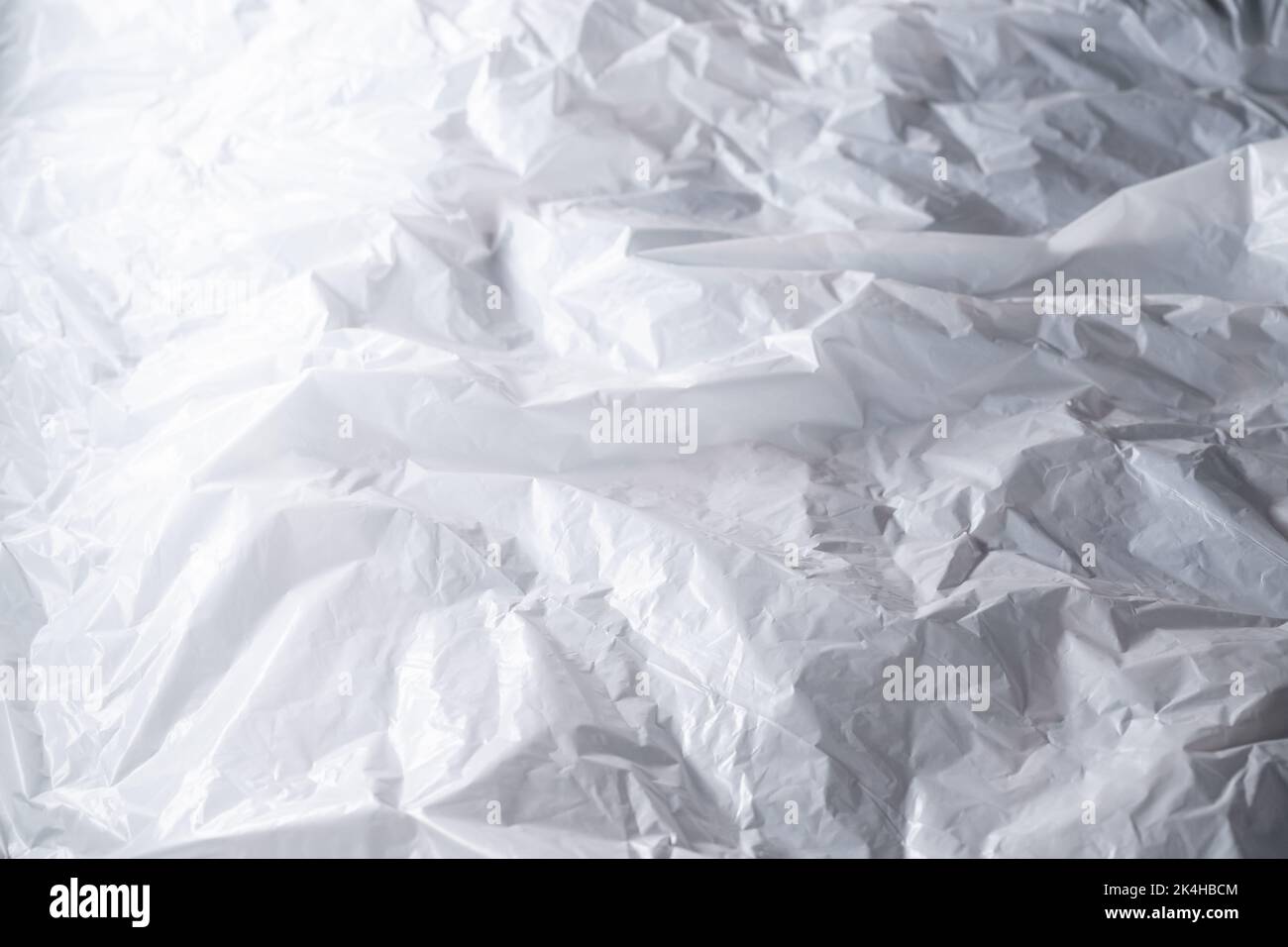 Reflecting light and shadow on creases and folds in scrunched white ...