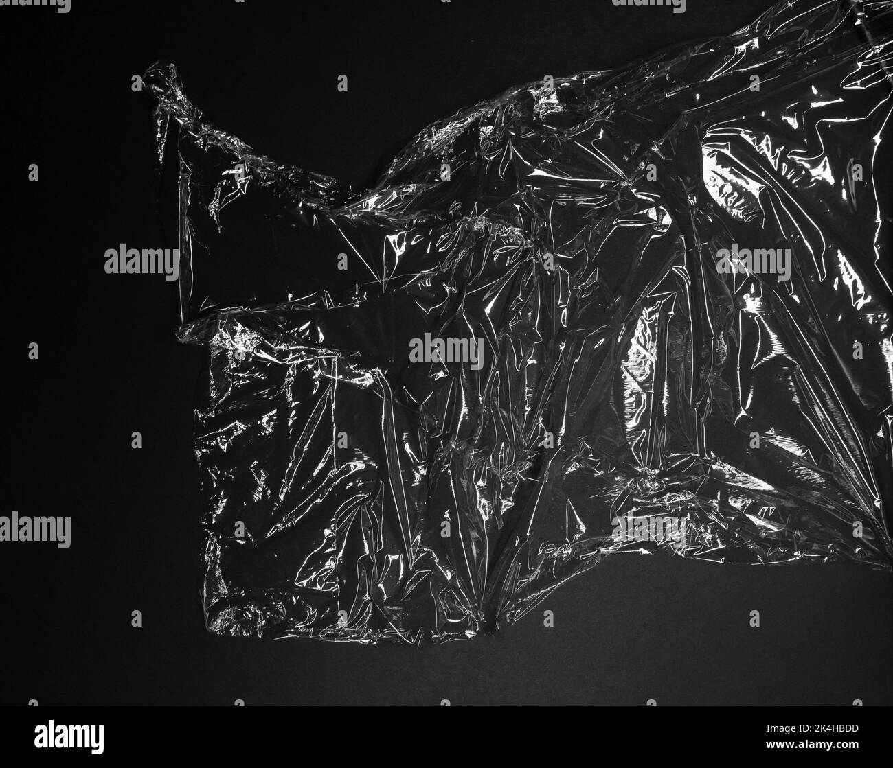 Reflecting light and shadow on creases and folds in scrunched clear ...