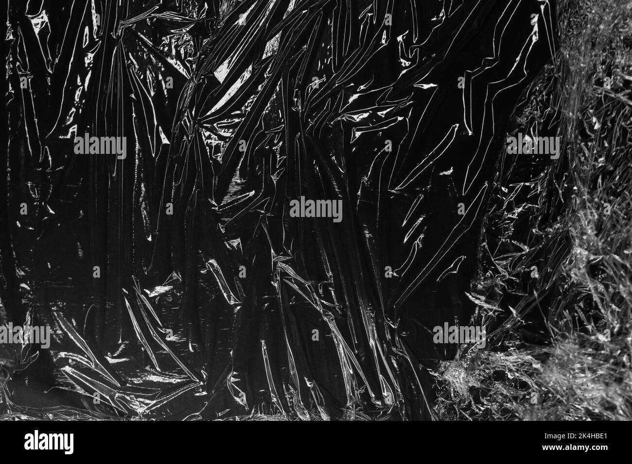 Reflecting light and shadow on creases and folds in scrunched plastic ...