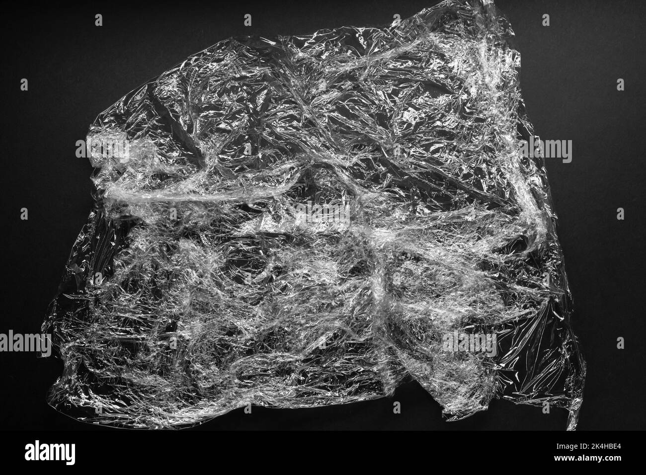 Reflecting light and shadow on creases and folds in scrunched clear ...