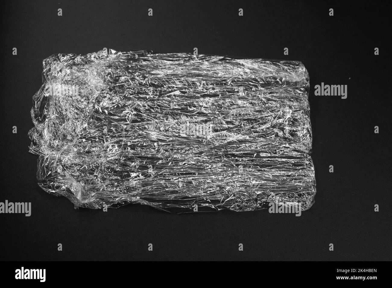 Reflecting light and shadow on creases and folds in scrunched clear ...