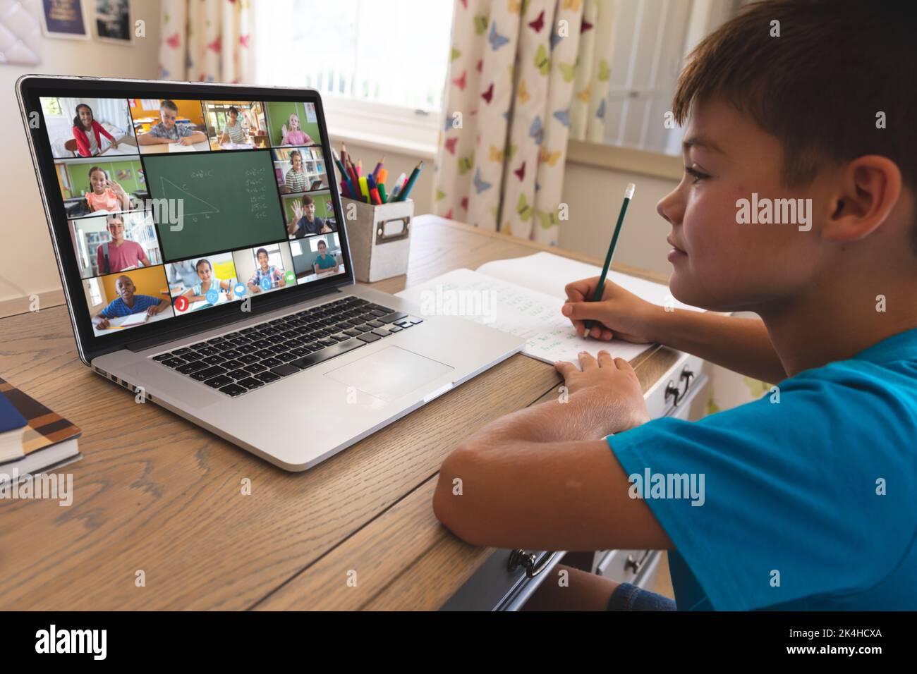 Caucasian boy using laptop for video call, with smiling diverse ...
