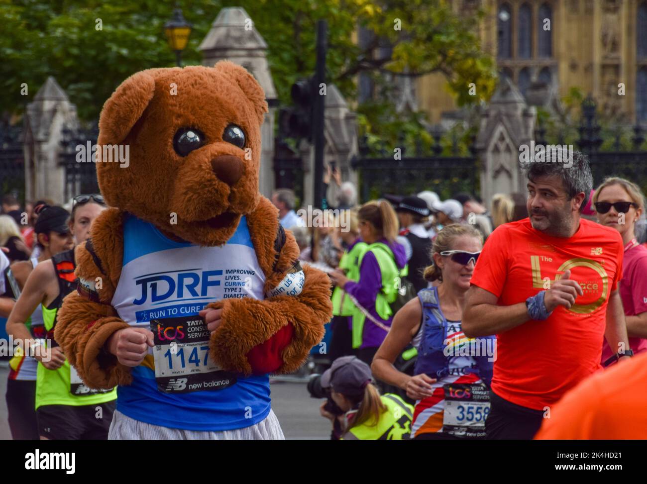 A runner dressed as a teddy bear passes through Parliament Square ...